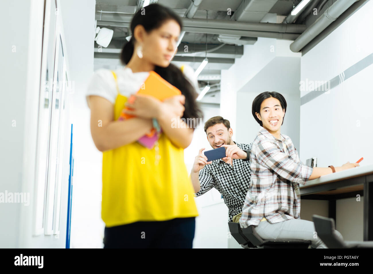 Rude young men laughing and taking photos of embarrassed girl Stock ...