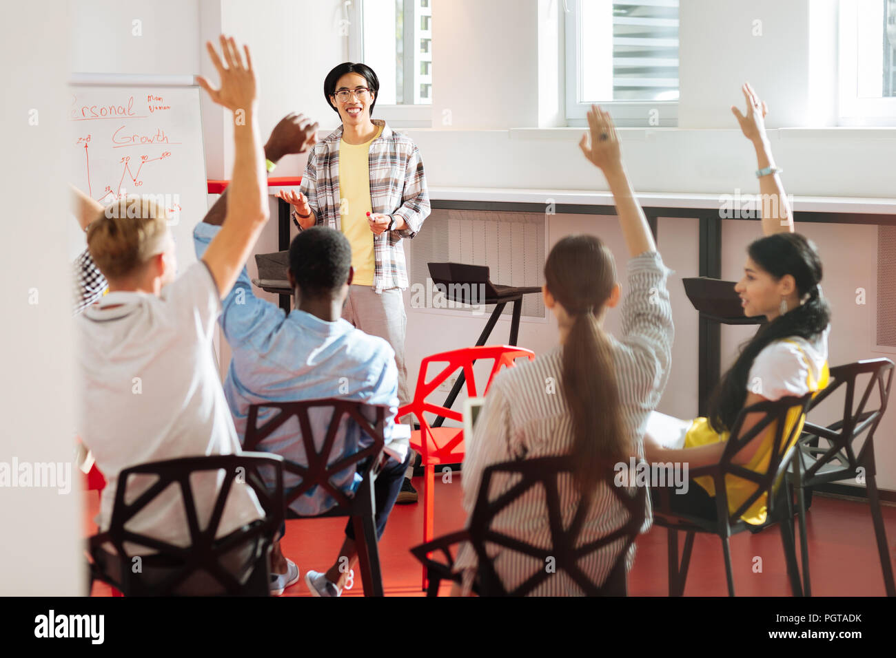 People interested in self growth raising hands and asking questions ...