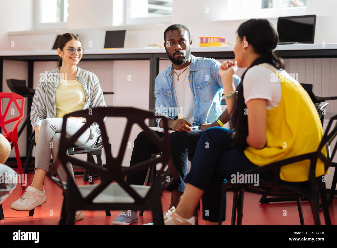 Calm people sitting in circle and having friendly conversation Stock ...