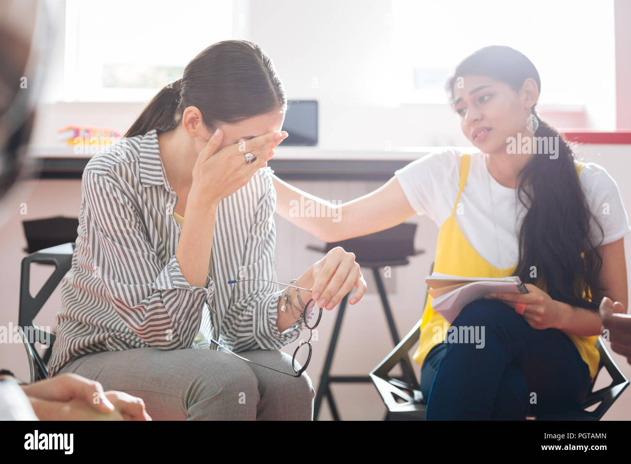 Kind girl looking at the crying person and showing her support and ...