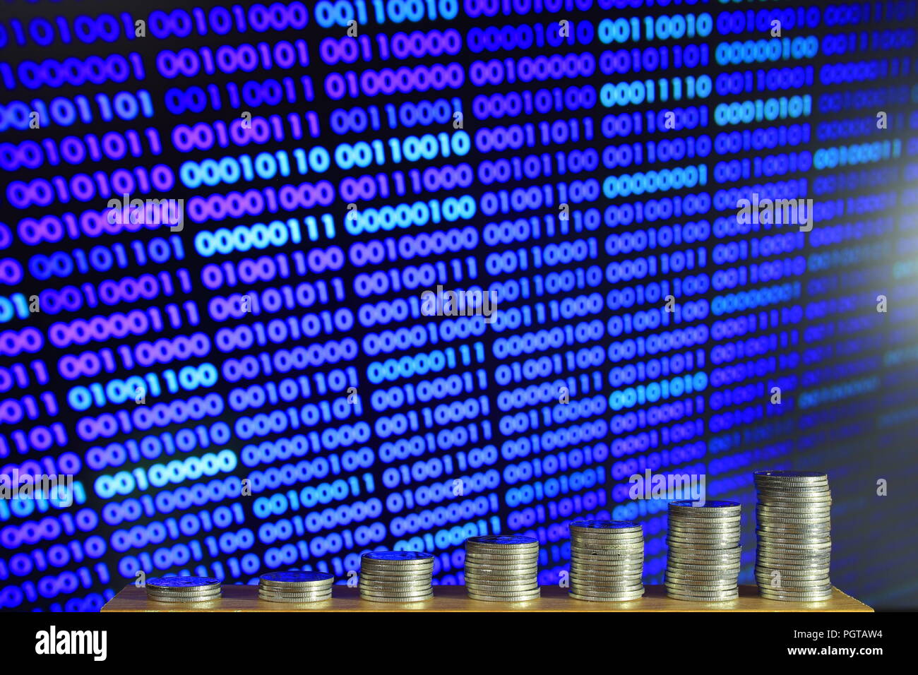 secured internet business. big coin piles in front of blue binary code ...