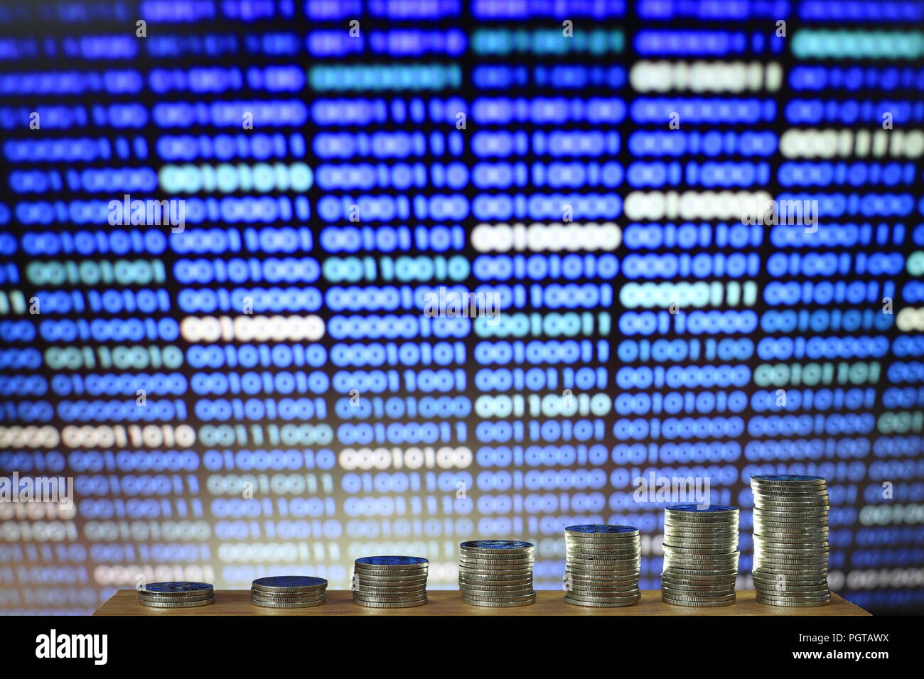 secured internet business. big coin piles in front of blue binary code ...