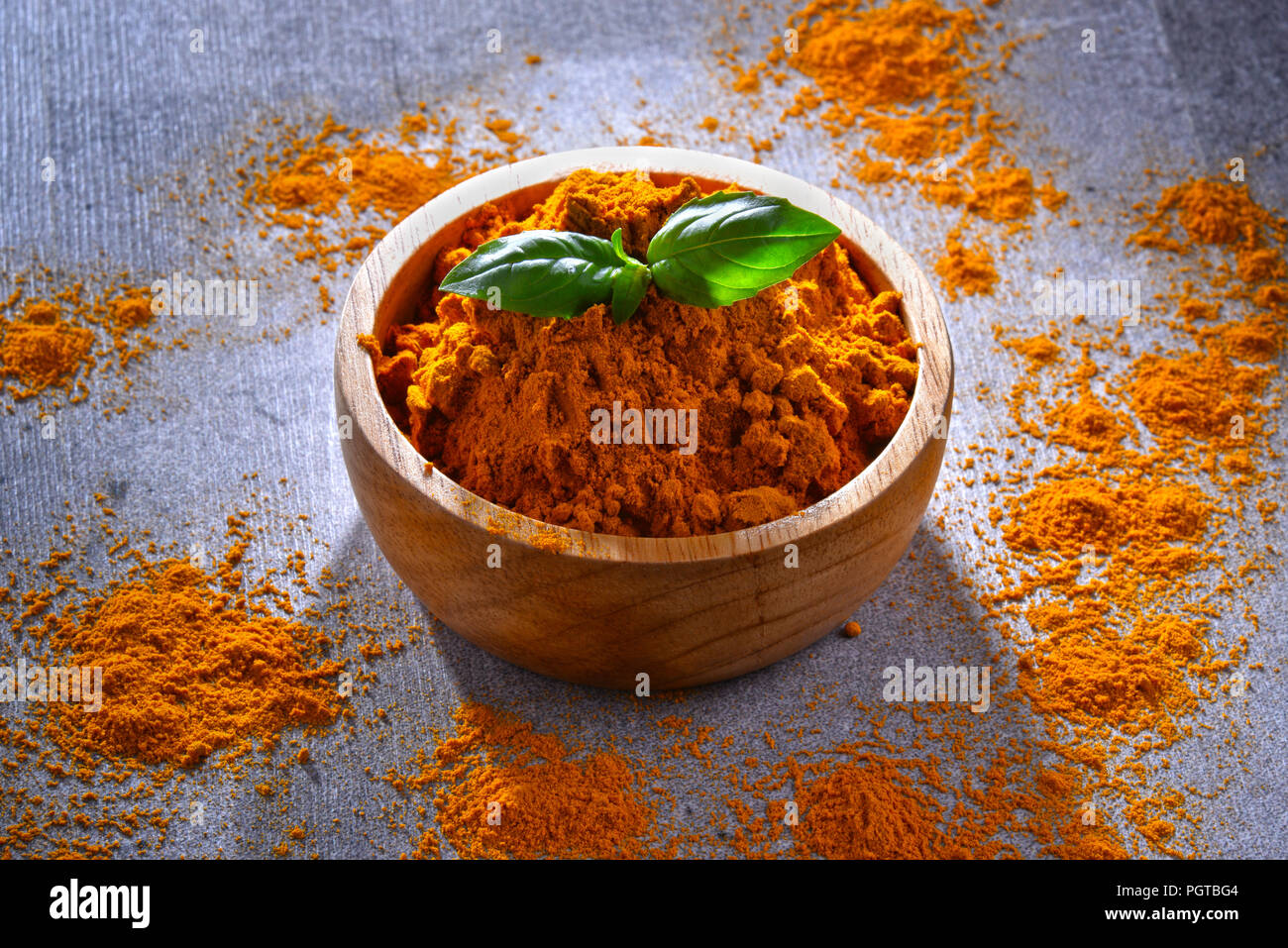 Composition with bowl of turmeric powder Stock Photo - Alamy