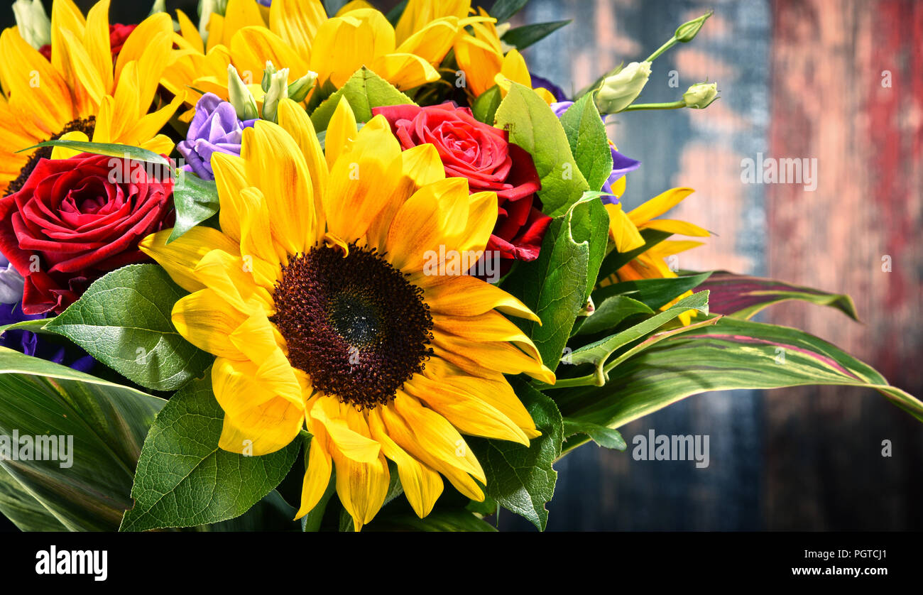 Composition with bouquet of flowers including sunflowers and roses ...