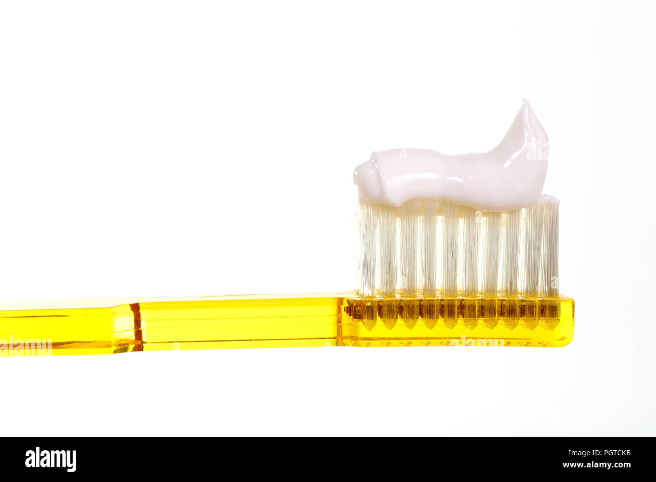 Close up of a toothbrush with toothpaste isolated on a white background ...
