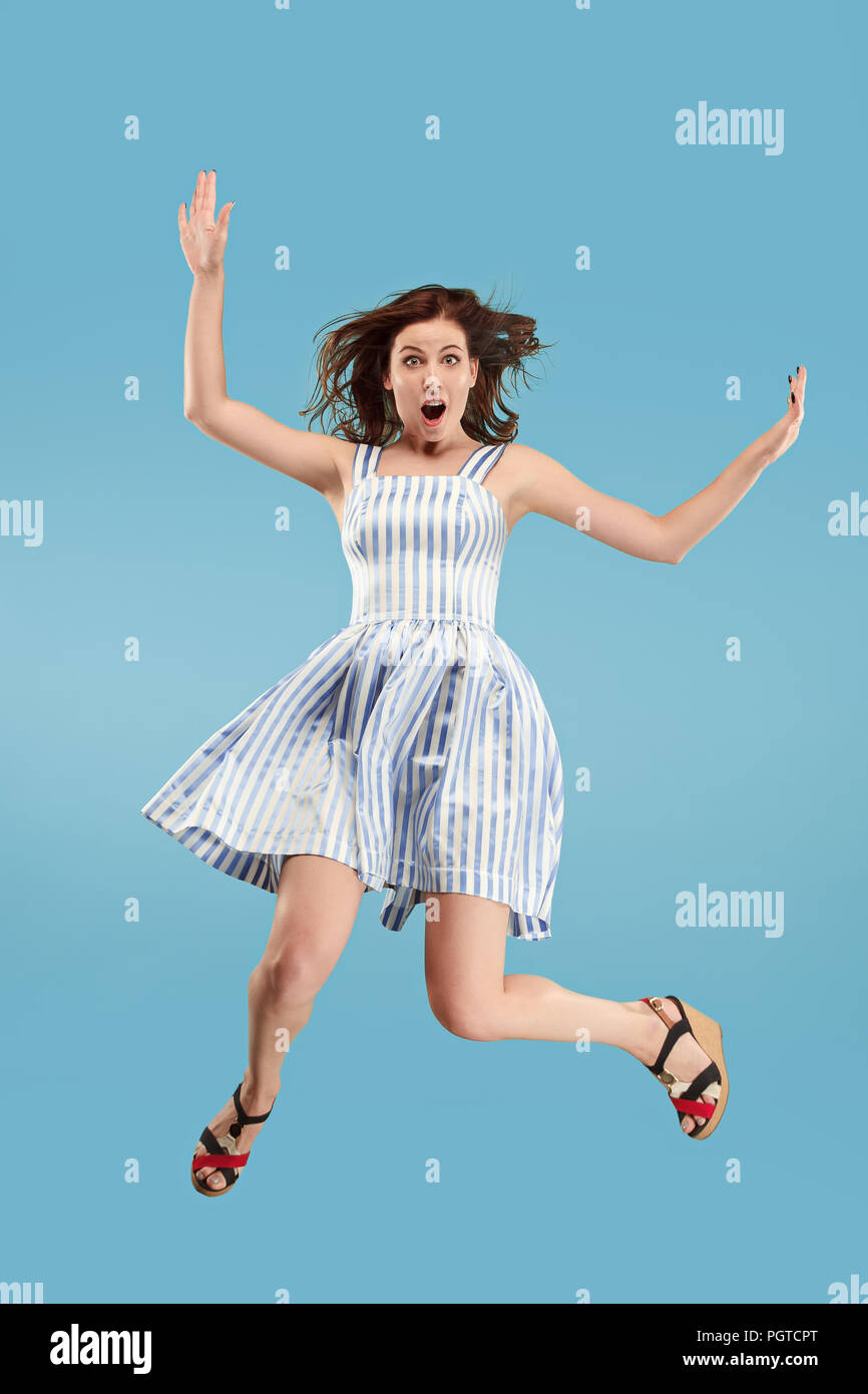 Freedom in moving. Surprised, pretty, happy young woman jumping and ...