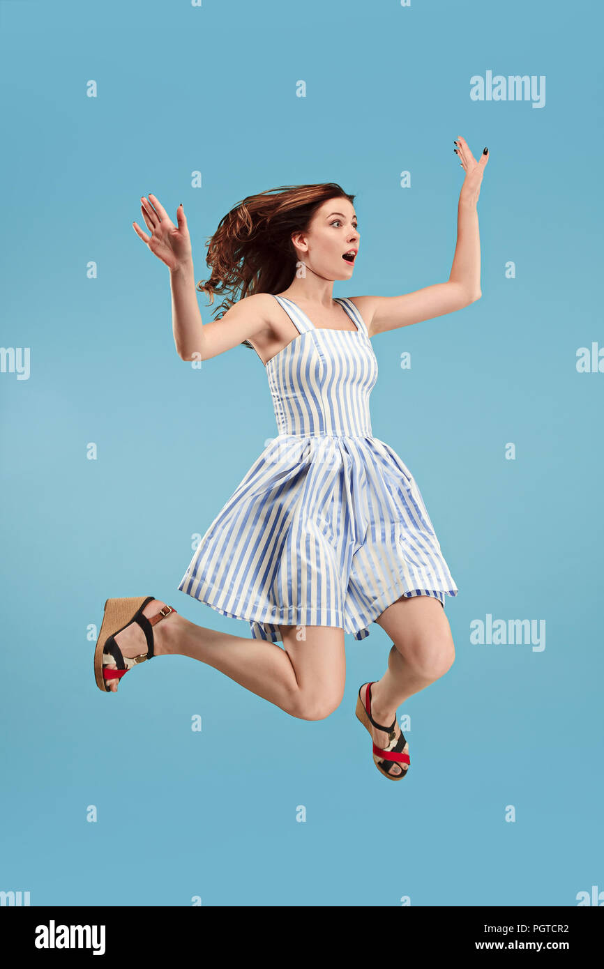 Freedom in moving. Surprised, pretty, happy young woman jumping and ...