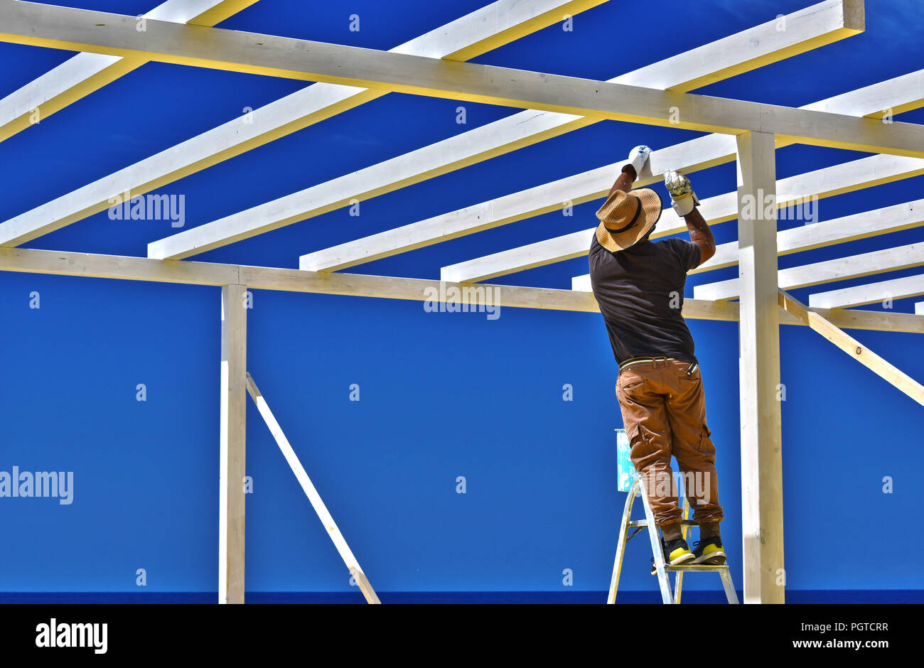 Man putting a wooden structure on the beach Stock Photo - Alamy