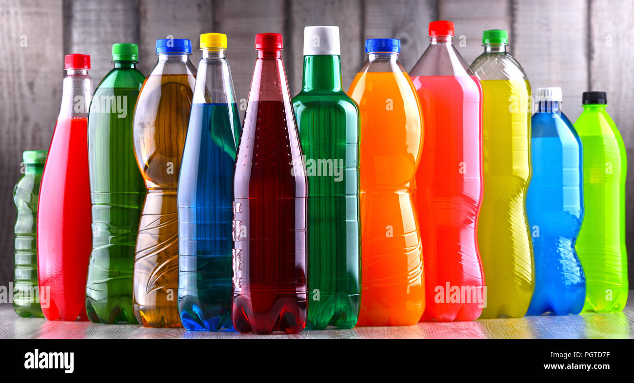 Plastic bottles of assorted carbonated soft drinks in variety of colors ...