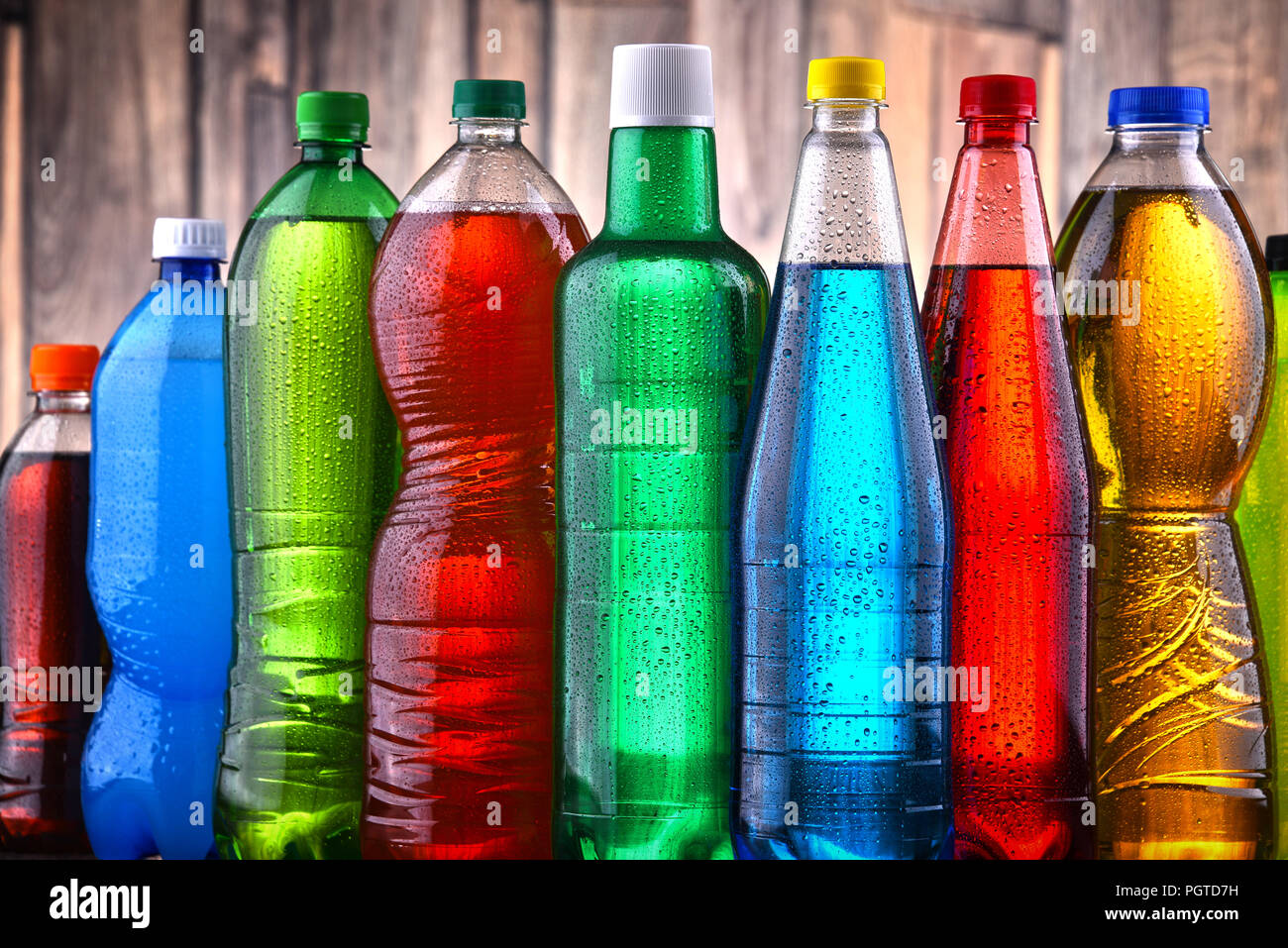 Plastic bottles of assorted carbonated soft drinks in variety of colors ...