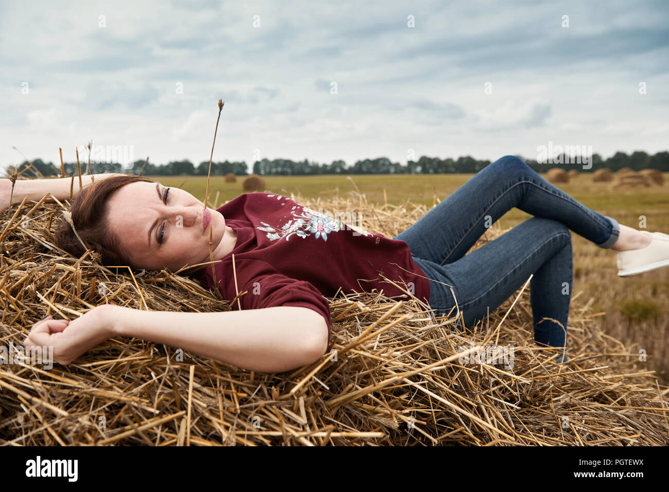 Girl lying on haystack hi-res stock photography and images - Alamy