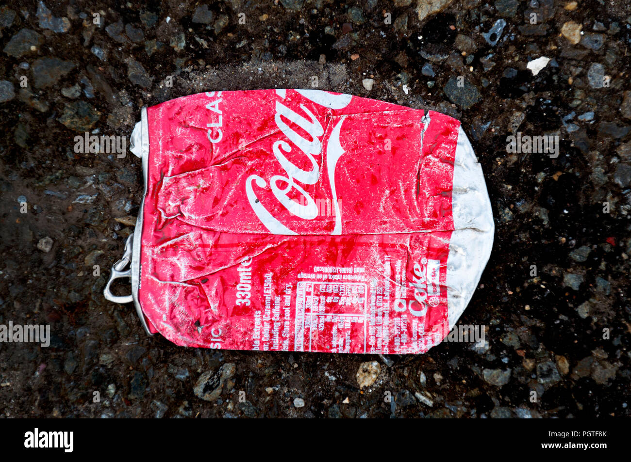 Squashed flat aluminium Coca Cola Coke beverage tin can in road Stock ...