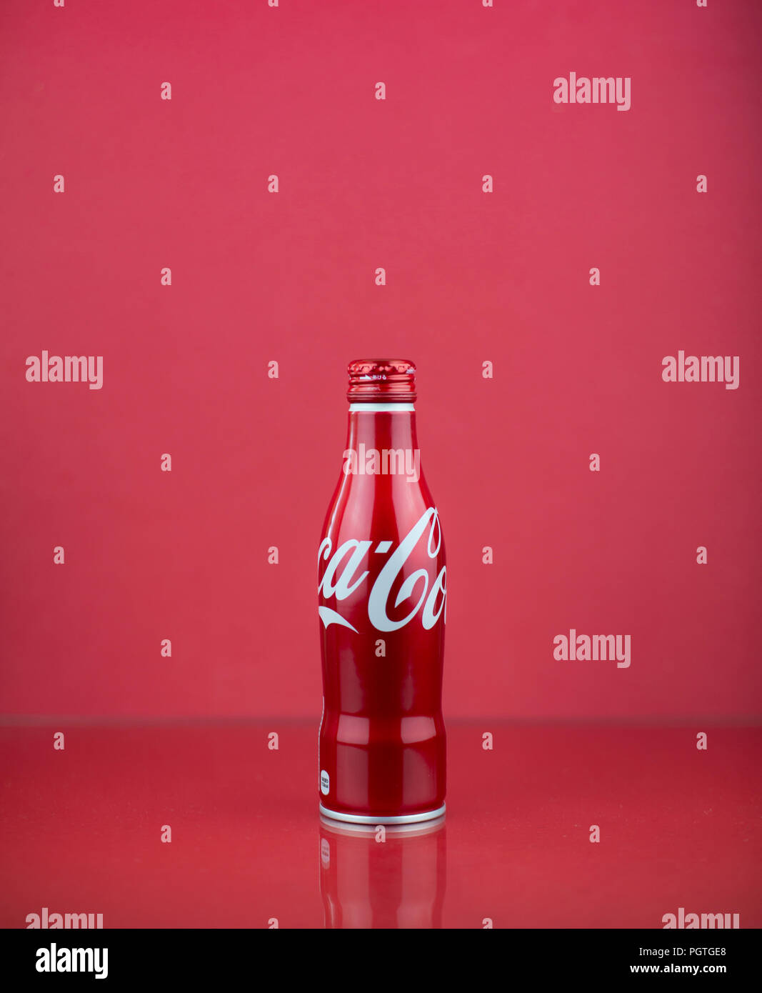 red aluminum coca-cola contour bottle on red background Stock Photo - Alamy