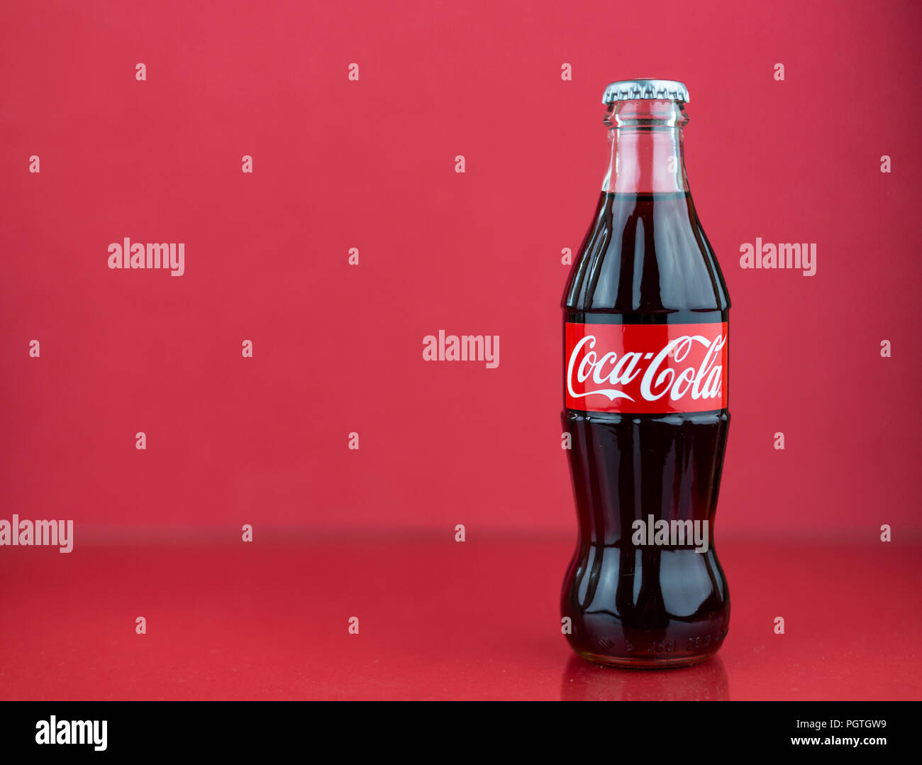 rare red coca-cola contour bottle on red background Stock Photo - Alamy