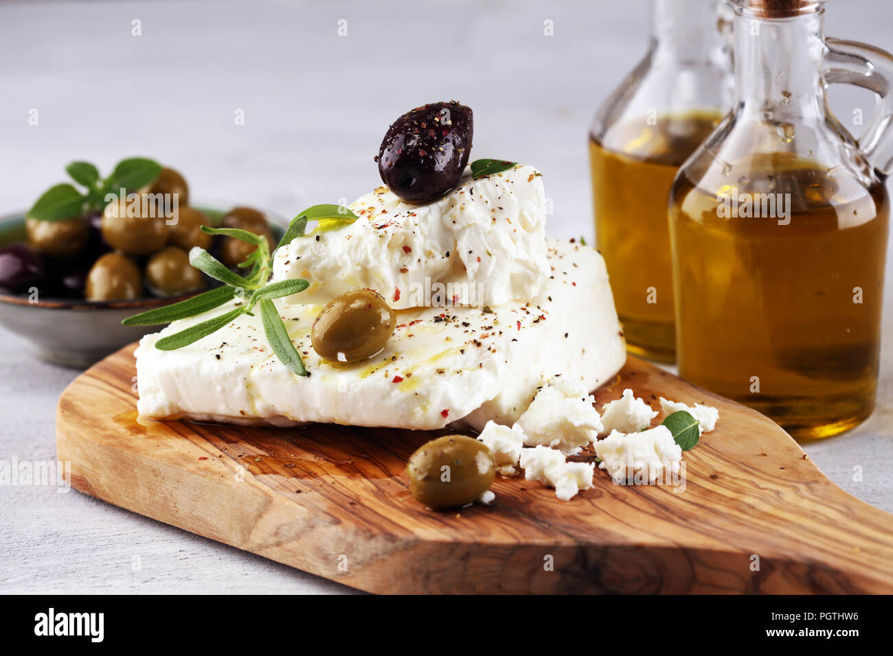 Greek cheese feta with herbs and olives on rustic table Stock Photo - Alamy