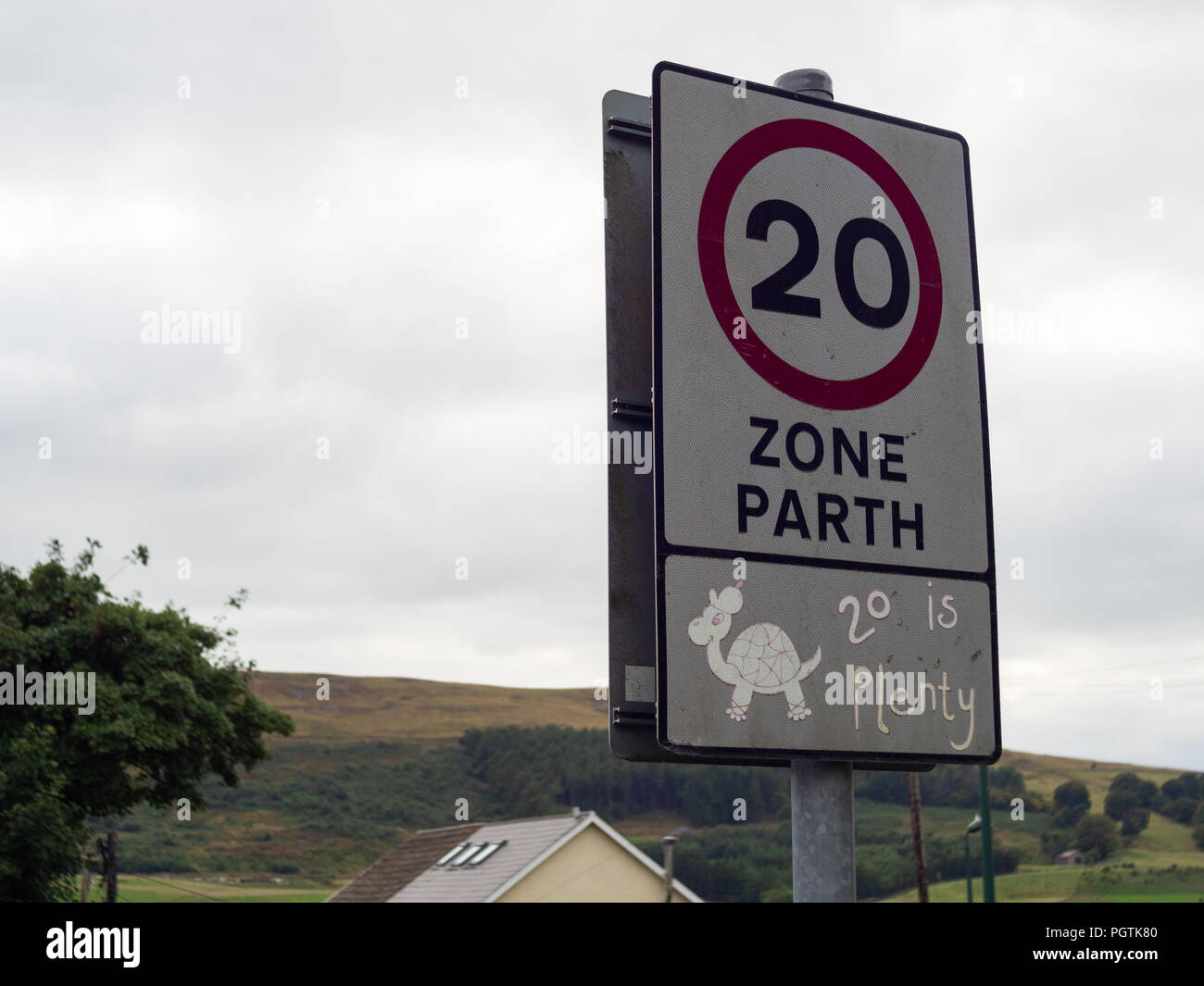 20 mph speed limit sign on public road, near a school, driving safety ...