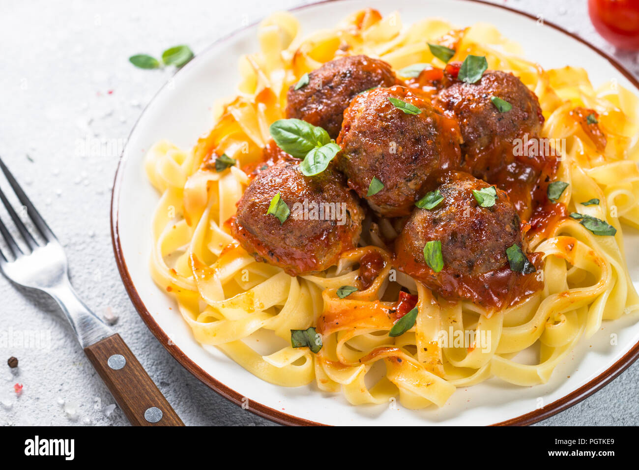 Meatballs in tomato sauce with pasta tagliatelle top view Stock Photo ...