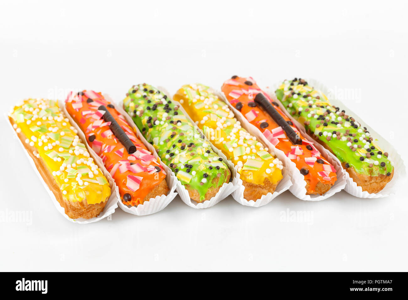 Sweet and colorful eclairs. Group of french dessert Eclair on white ...