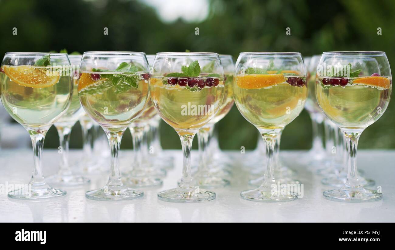 Three colorful cocktails in large wine glasses in a classic bar ...