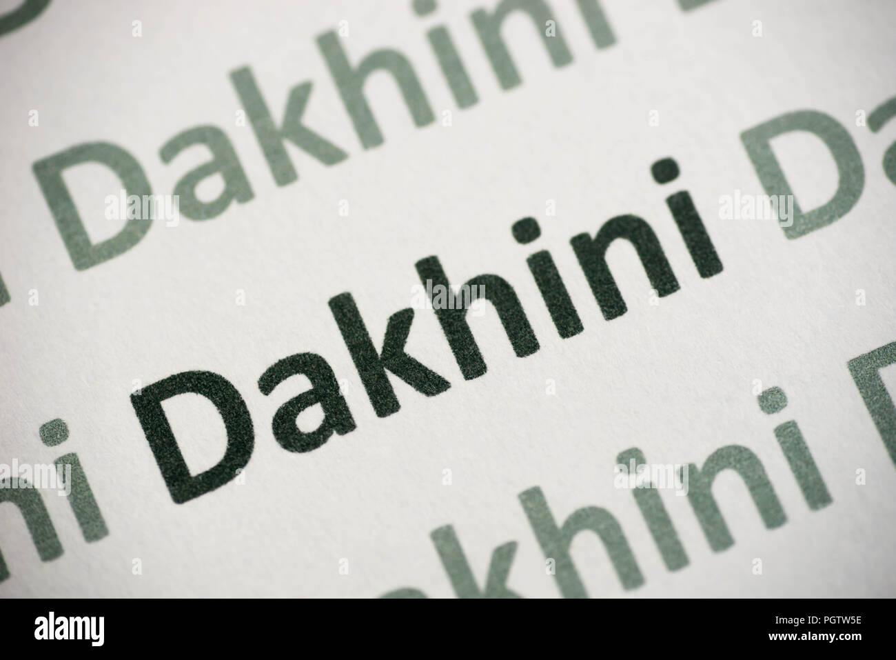 word Dakhini language printed on white paper macro Stock Photo - Alamy