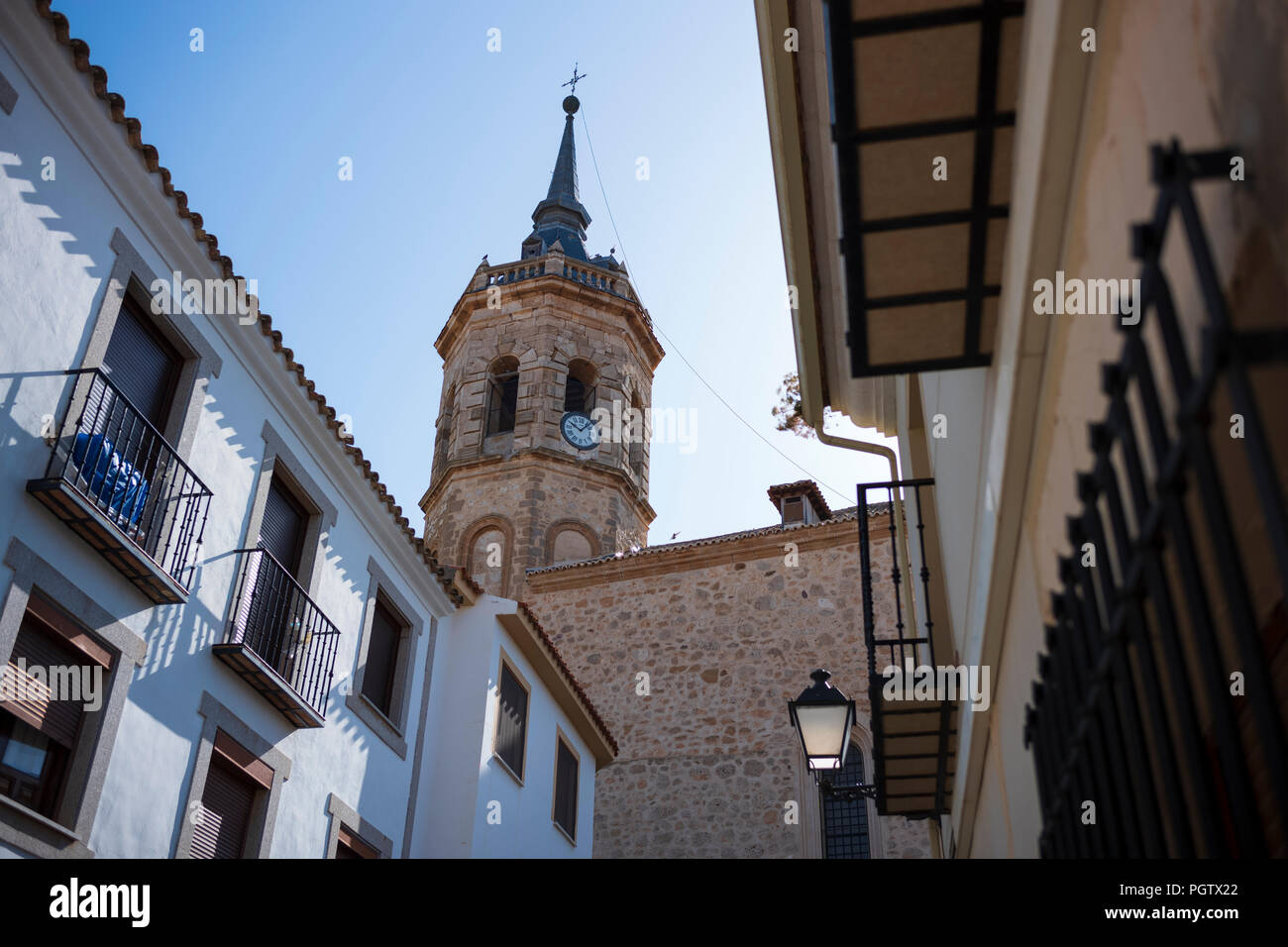 Tembleque, Spain, is a small village with a church and clock tower at ...