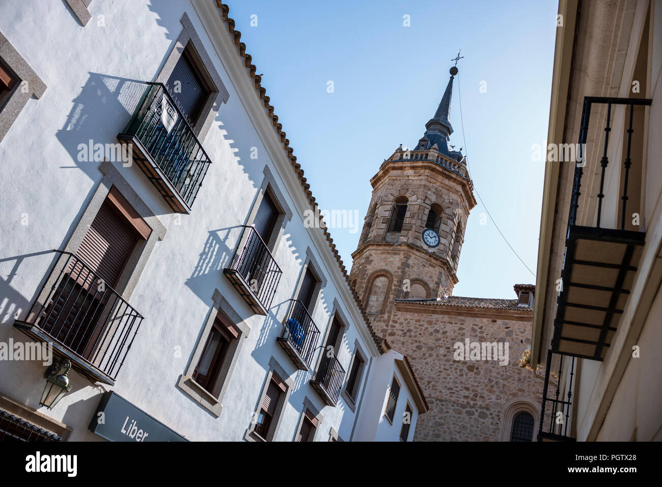 Tembleque, Spain, is a small village with a church and clock tower at ...