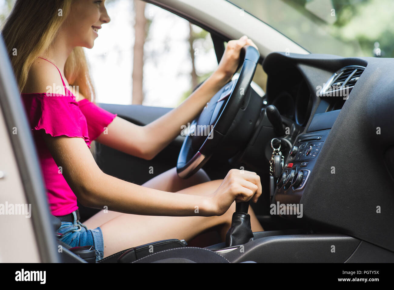 Girl smile and learn how to drive Stock Photo - Alamy