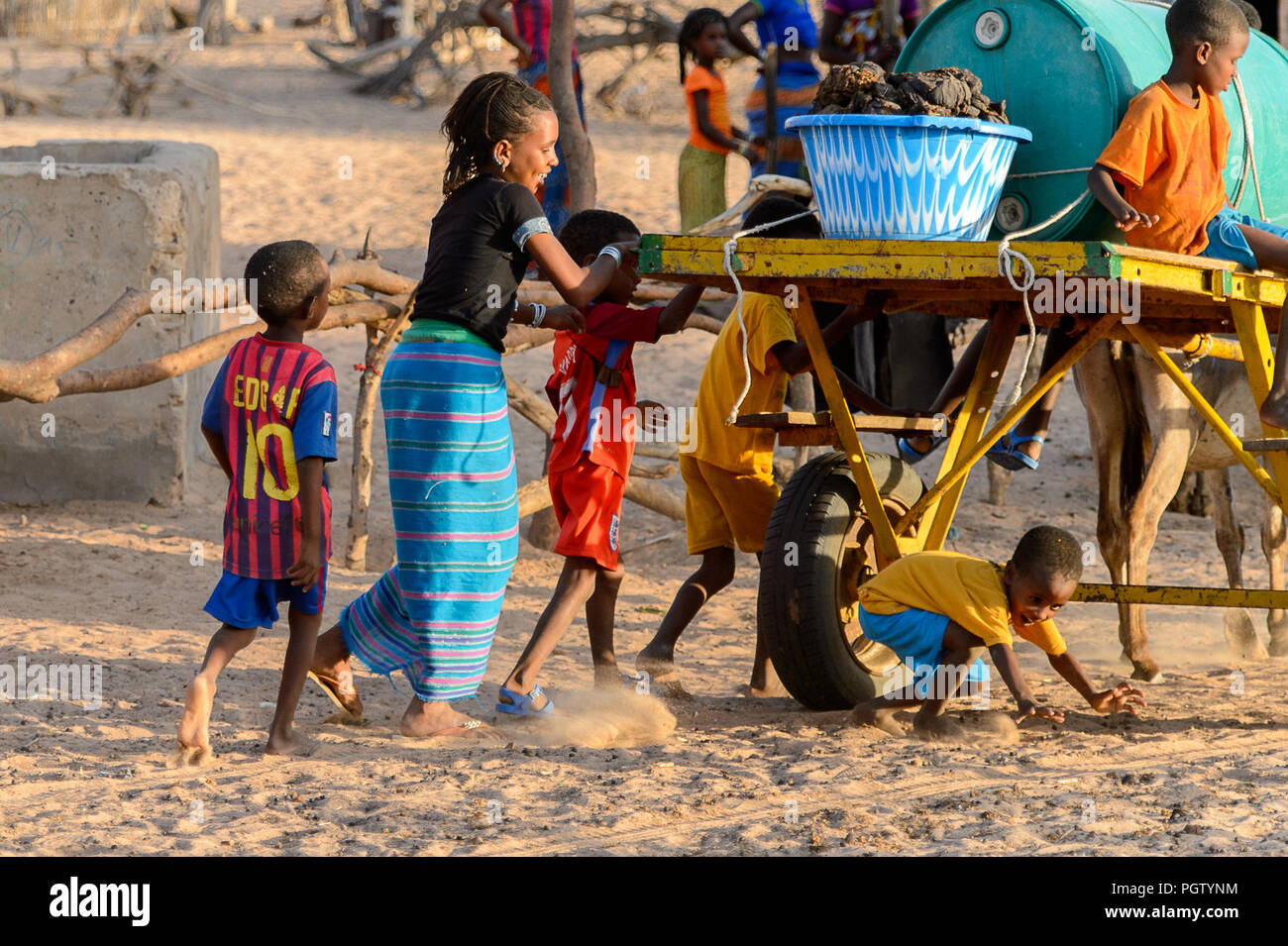 FERLO DESERT, SENEGAL - APR 25, 2017: Unidentified Fulani people ride ...