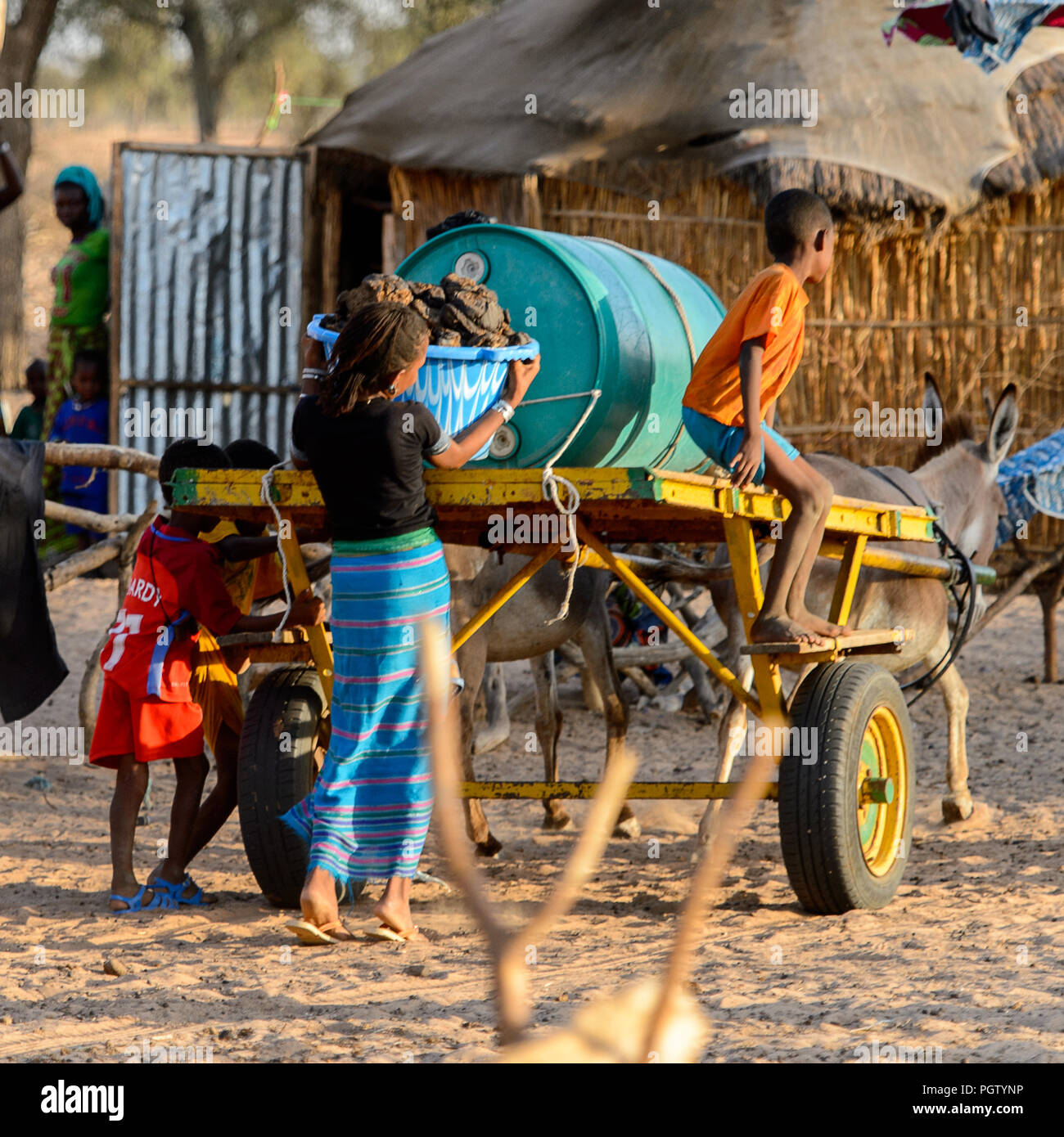 FERLO DESERT, SENEGAL - APR 25, 2017: Unidentified Fulani people ride ...