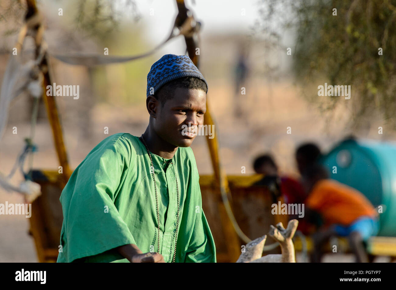 FERLO DESERT, SENEGAL - APR 25, 2017: Unidentified Fulani boy in green ...
