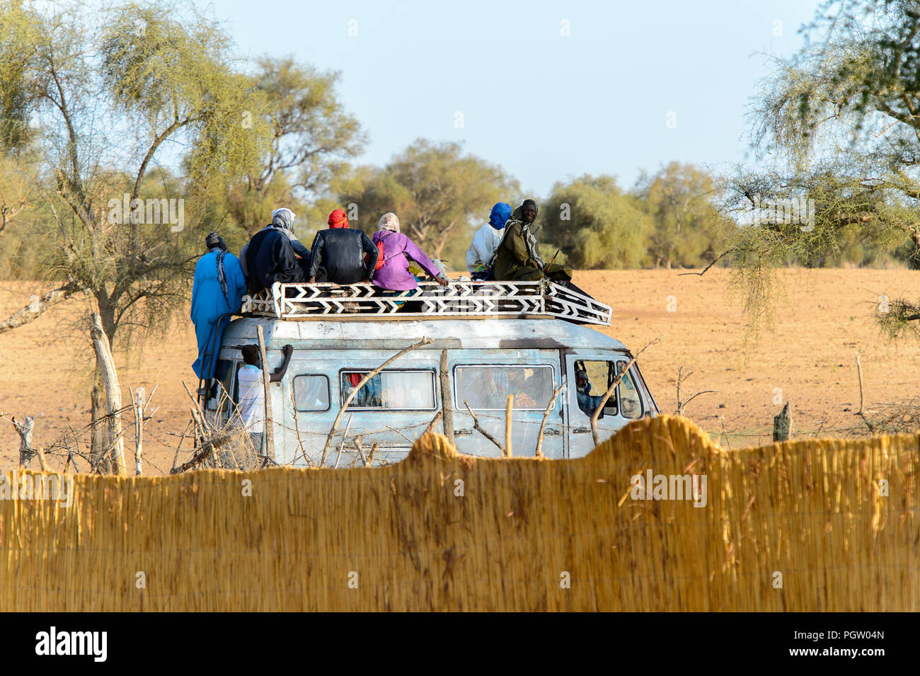 FERLO DESERT, SENEGAL - APR 25, 2017: Unidentified Fulani people ride ...