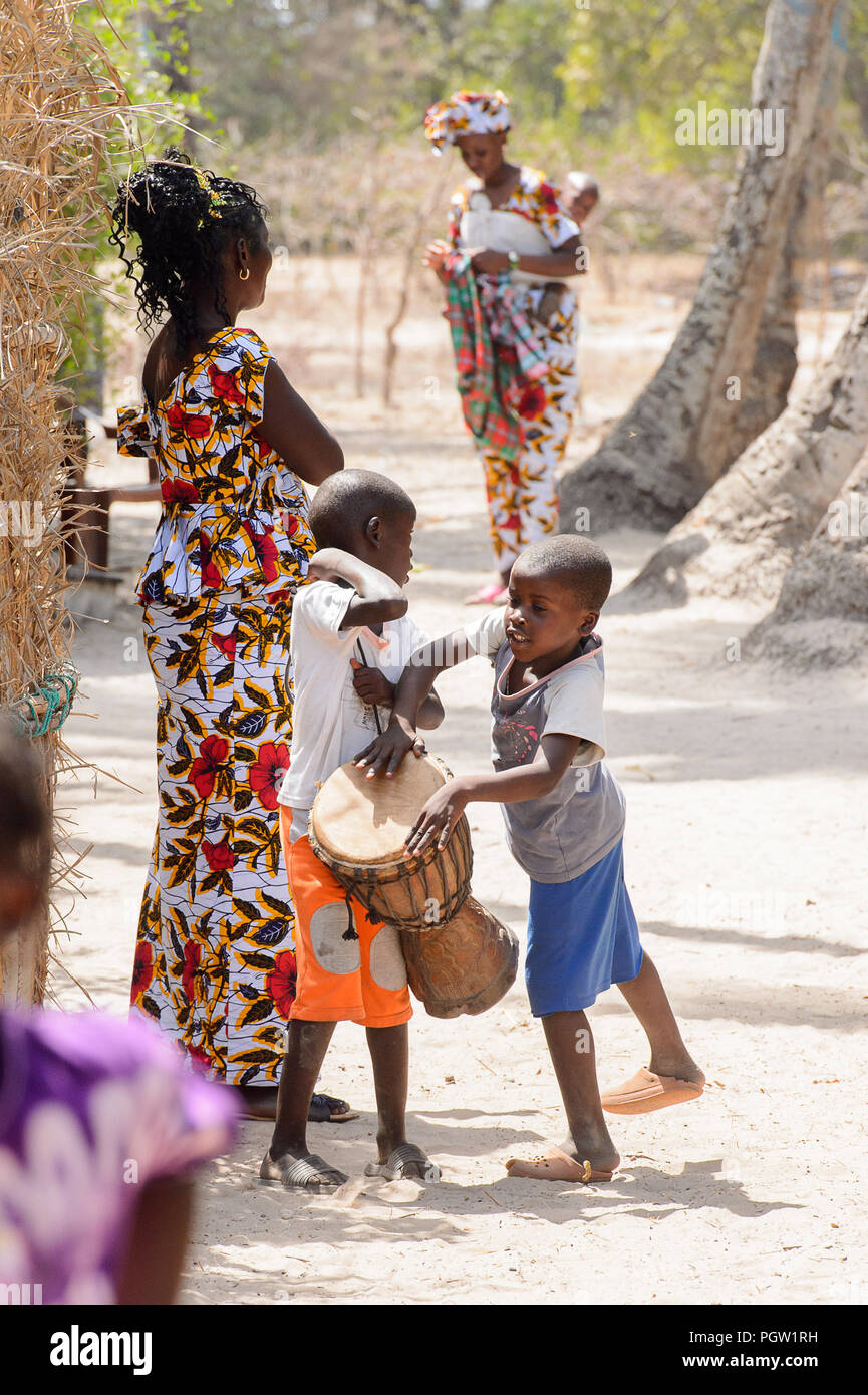KASCHOUANE, SENEGAL - APR 29, 2017: Unidentified Diola boy carries a ...