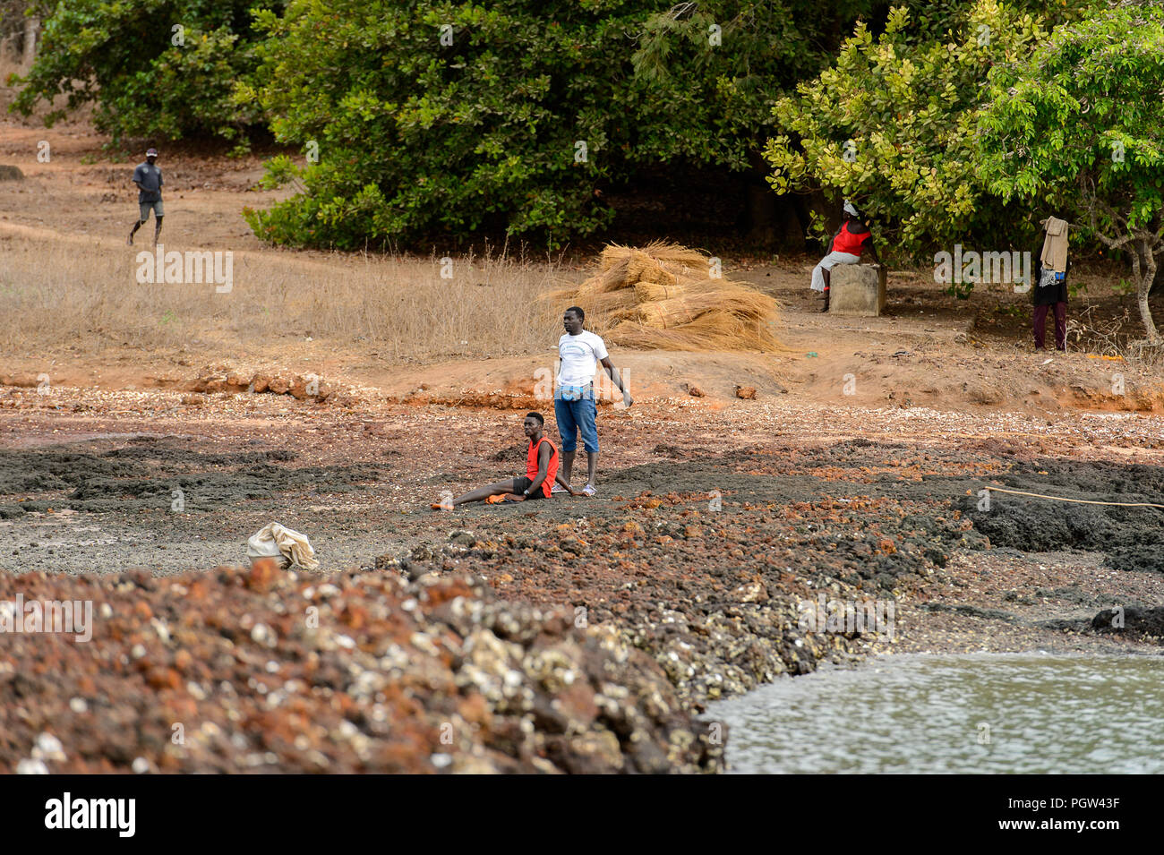 SOGA, GUINEA BISSAU - MAY 5, 2017: Unidentified local people rest on ...