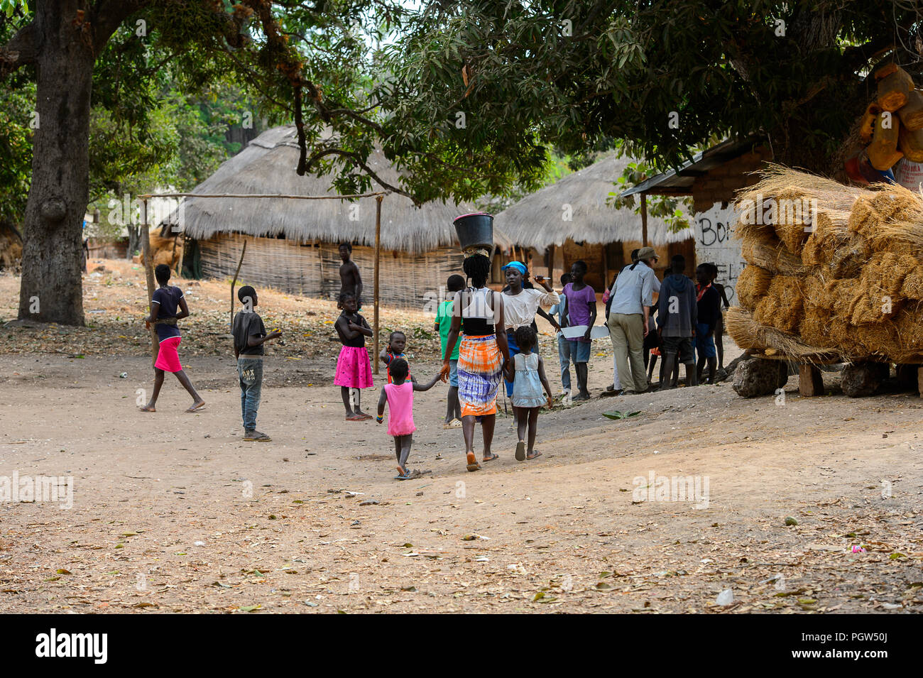 SOGA, GUINEA BISSAU - MAY 5, 2017: Unidentified local people walk along ...