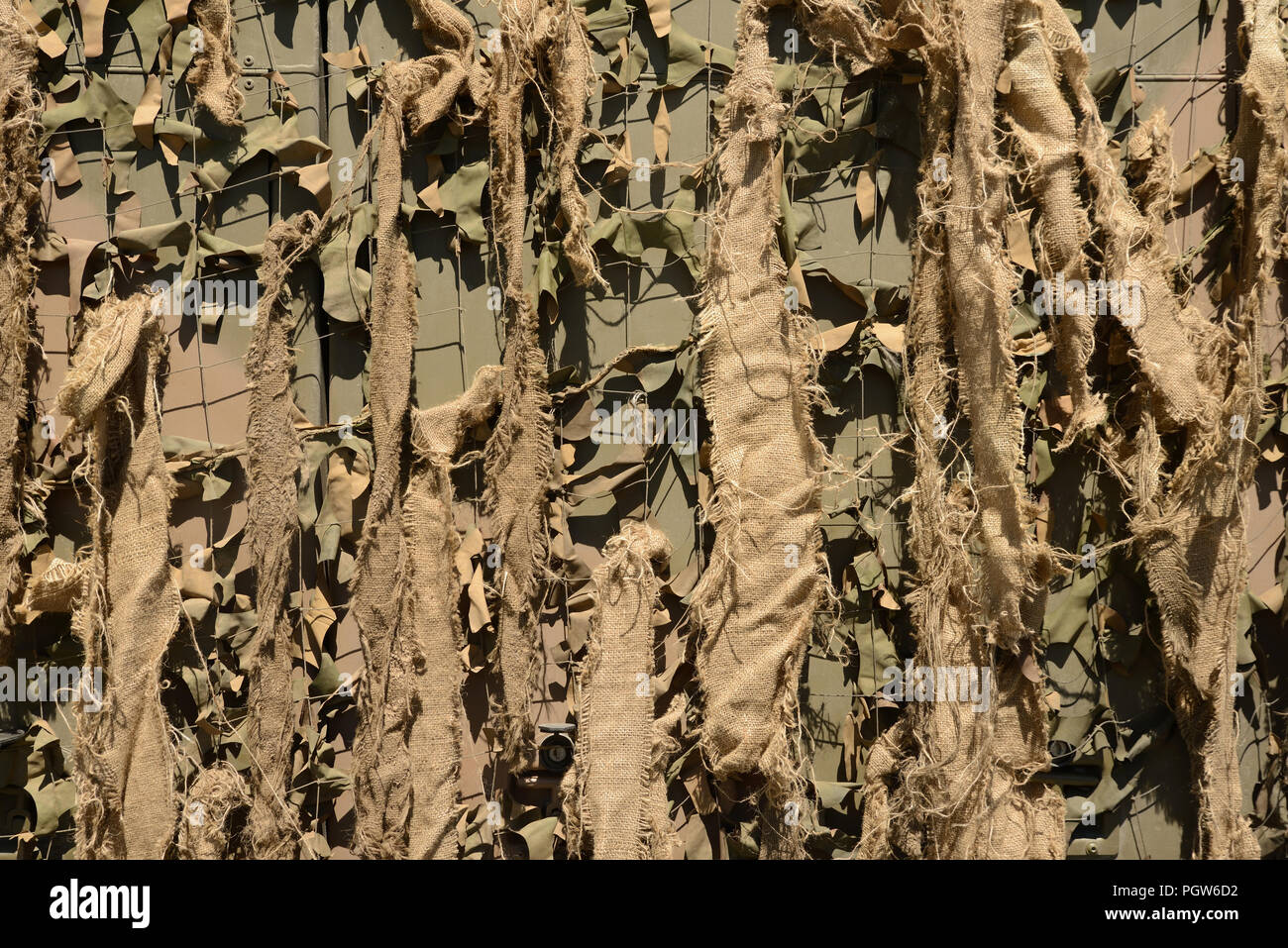 A drab background of army camouflage netting hung on a vehicle Stock ...