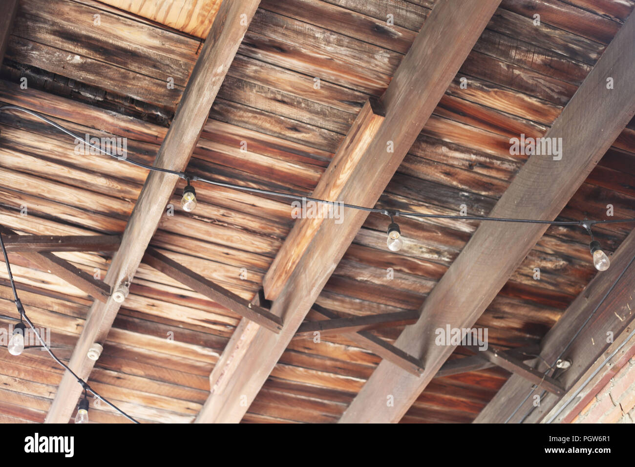 Wooden beams with lightbulb twinkle lights Stock Photo - Alamy