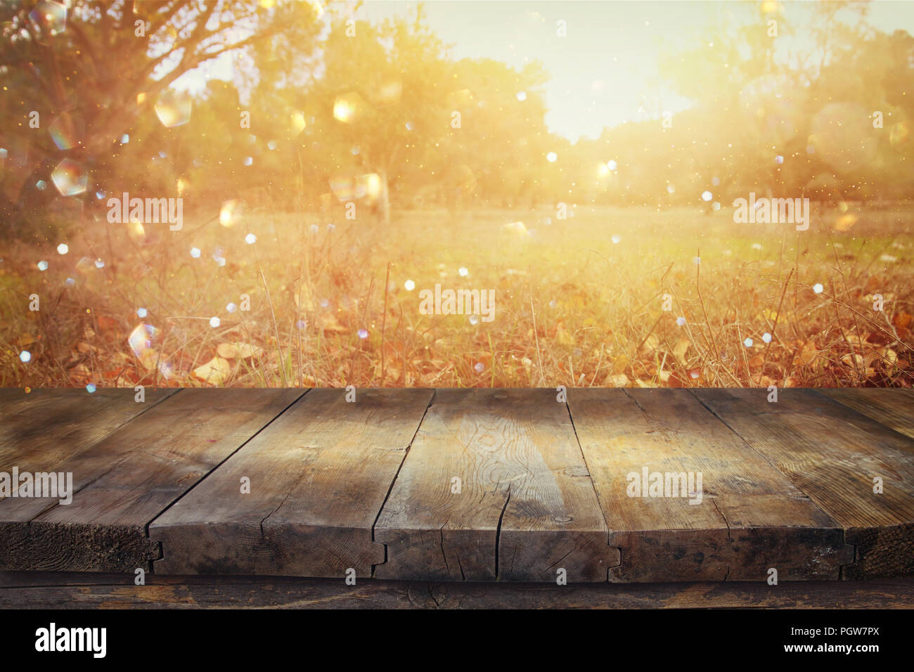 image of front rustic wood boards and background of fall leaves in ...