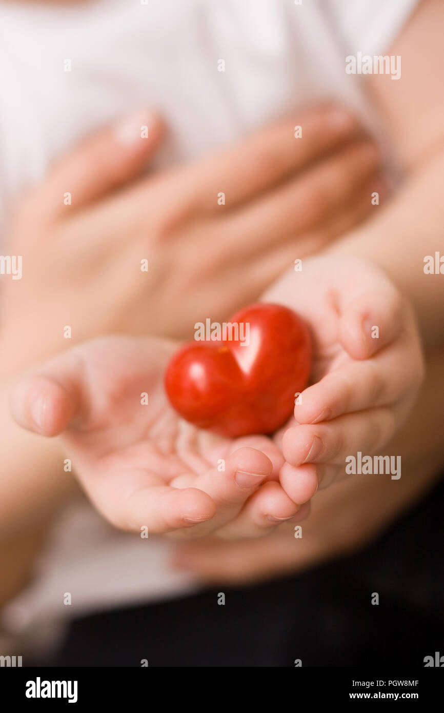 Red heart in child's hands. Love. Happiness. Care. Healthcare ...