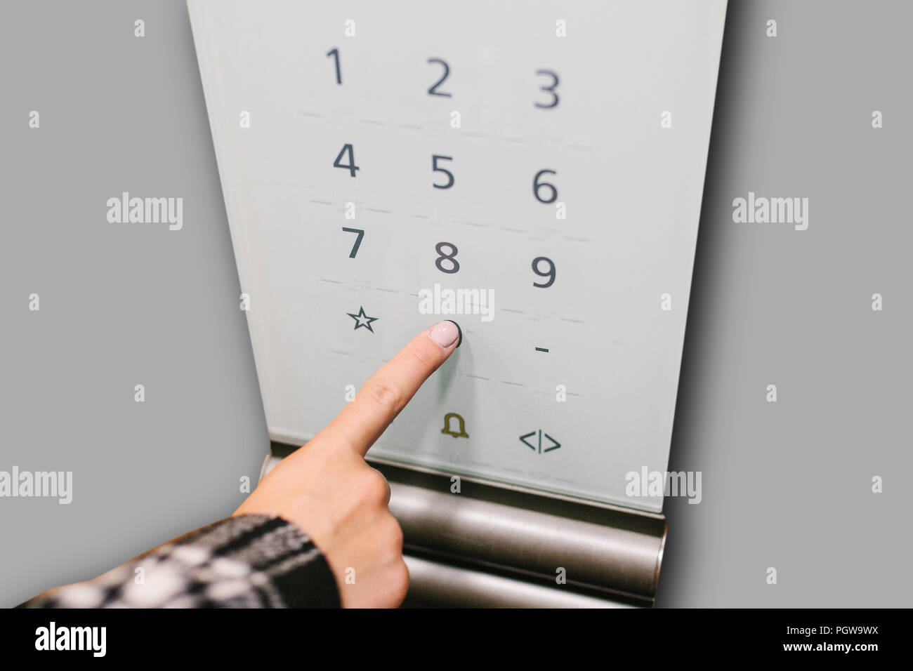 Close-up of a girl pressing a touch button in a modern elevator Stock ...