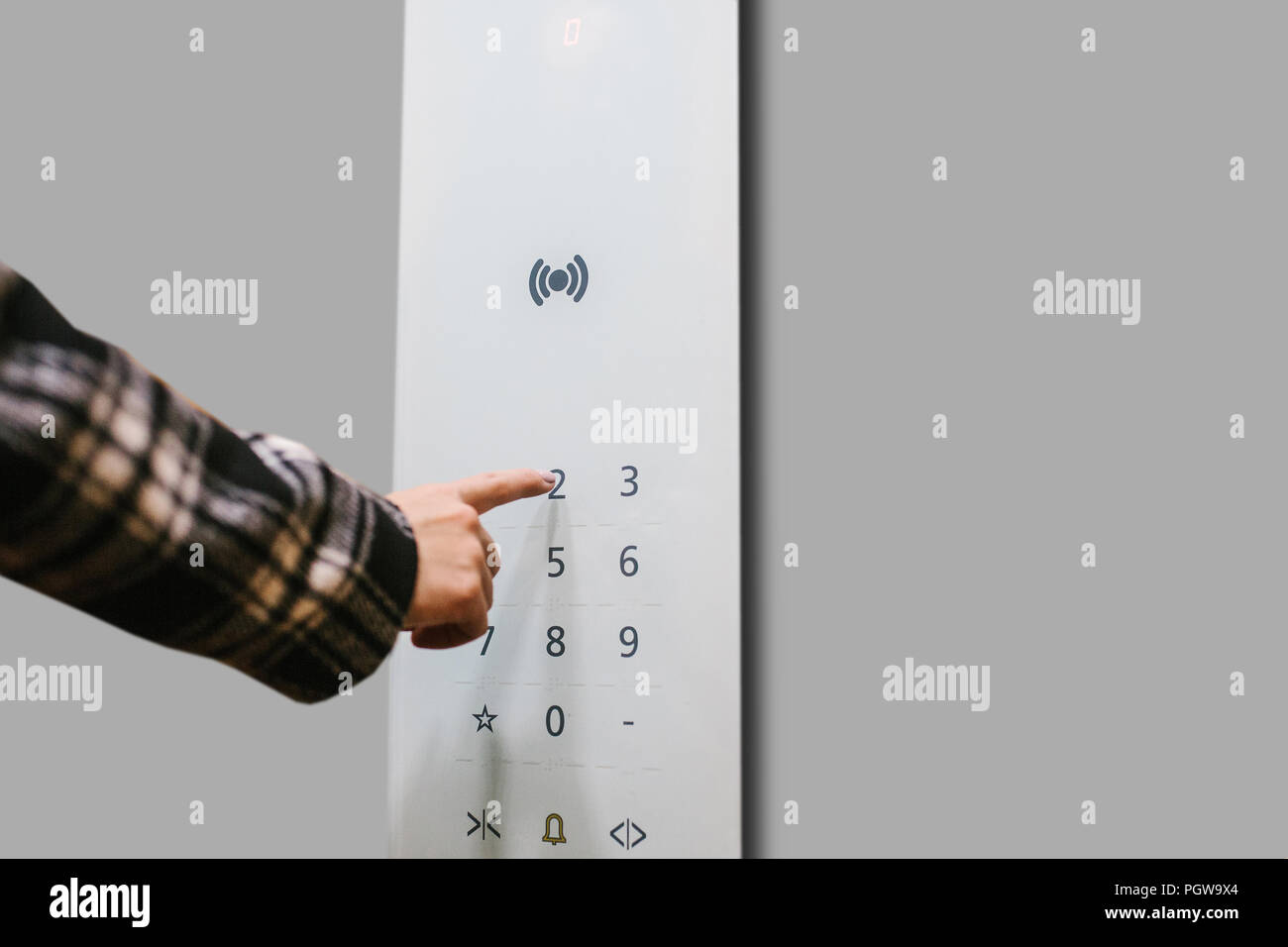 Close-up of a girl pressing a touch button in a modern elevator Stock ...