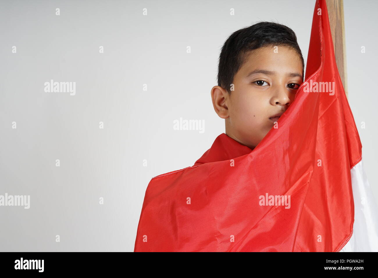 Teenage Boy covered with Red Flag (Indonesian Flag Stock Photo - Alamy