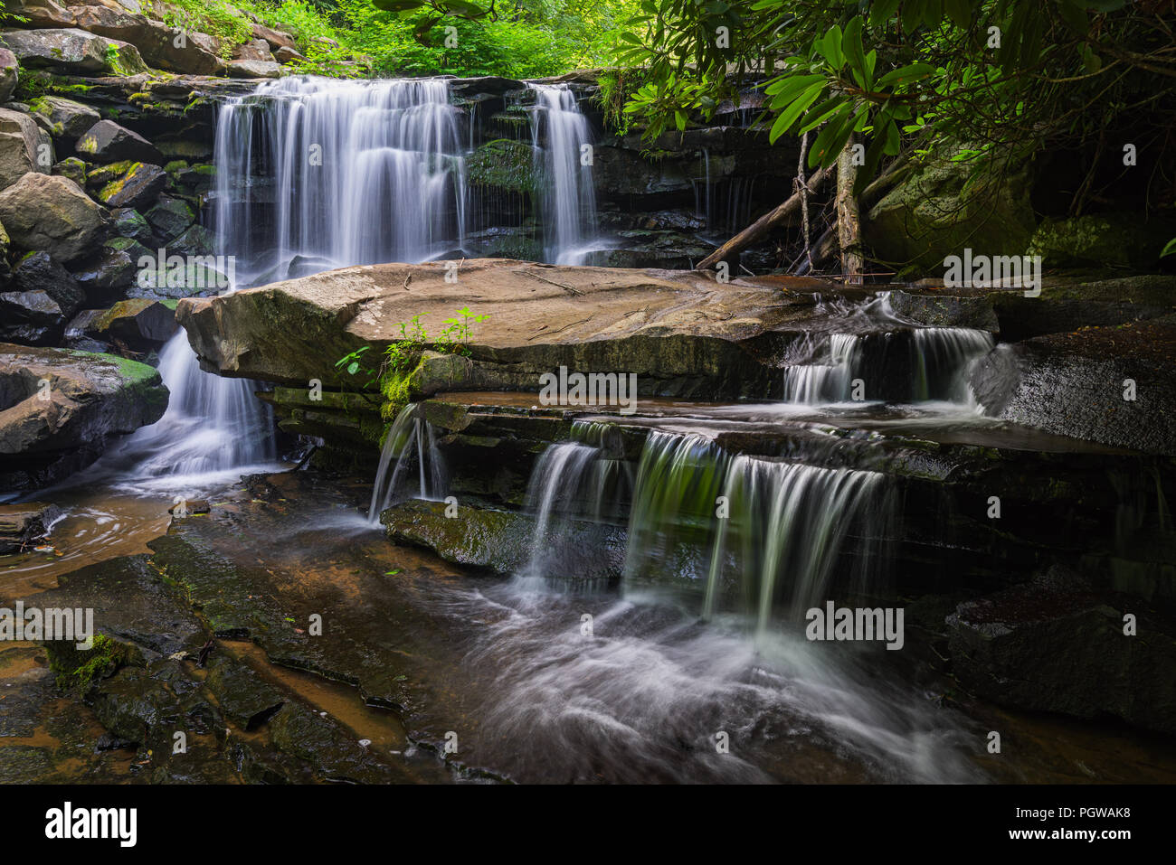 A waterfall within the New River Gorge flows and cascades over several ...
