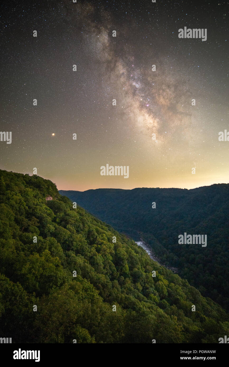 The Milky Way and the red planet mars stand above an exposed buttress ...