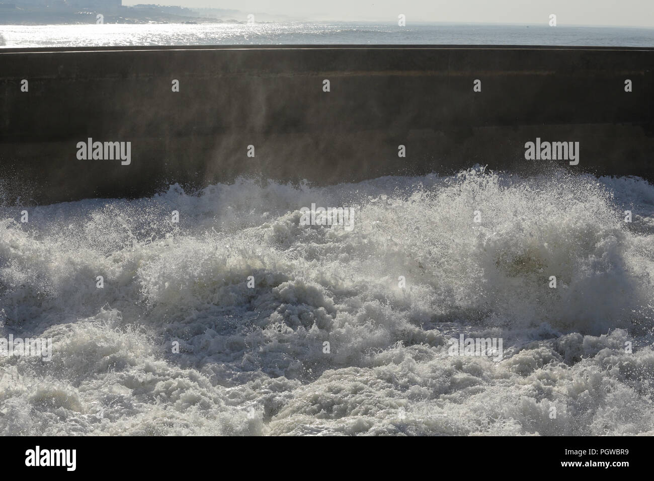 Violent waves breaking along a pier from the north of Portugal Stock ...
