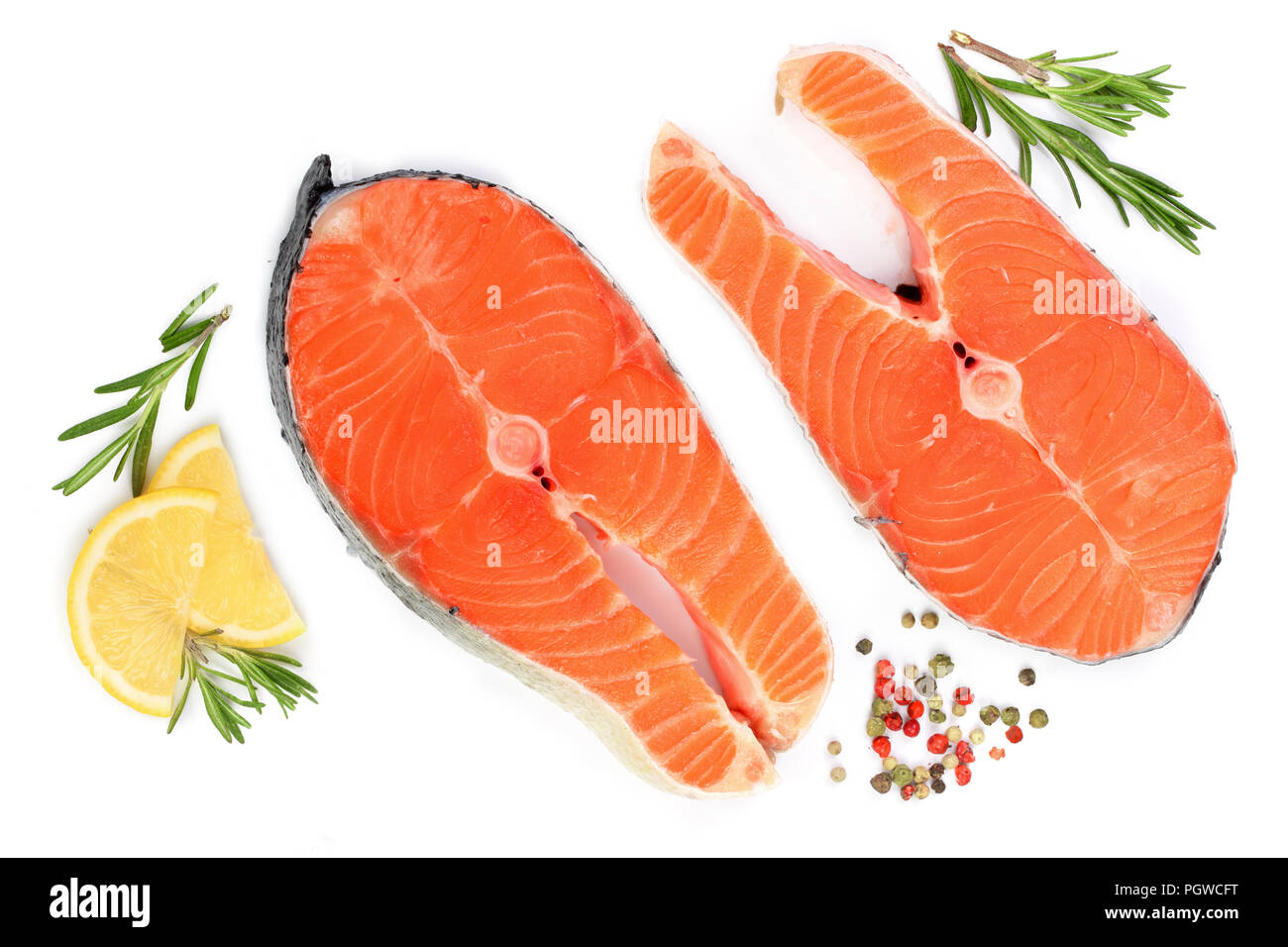 Slice of red fish salmon with lemon, rosemary and peppercorns isolated ...