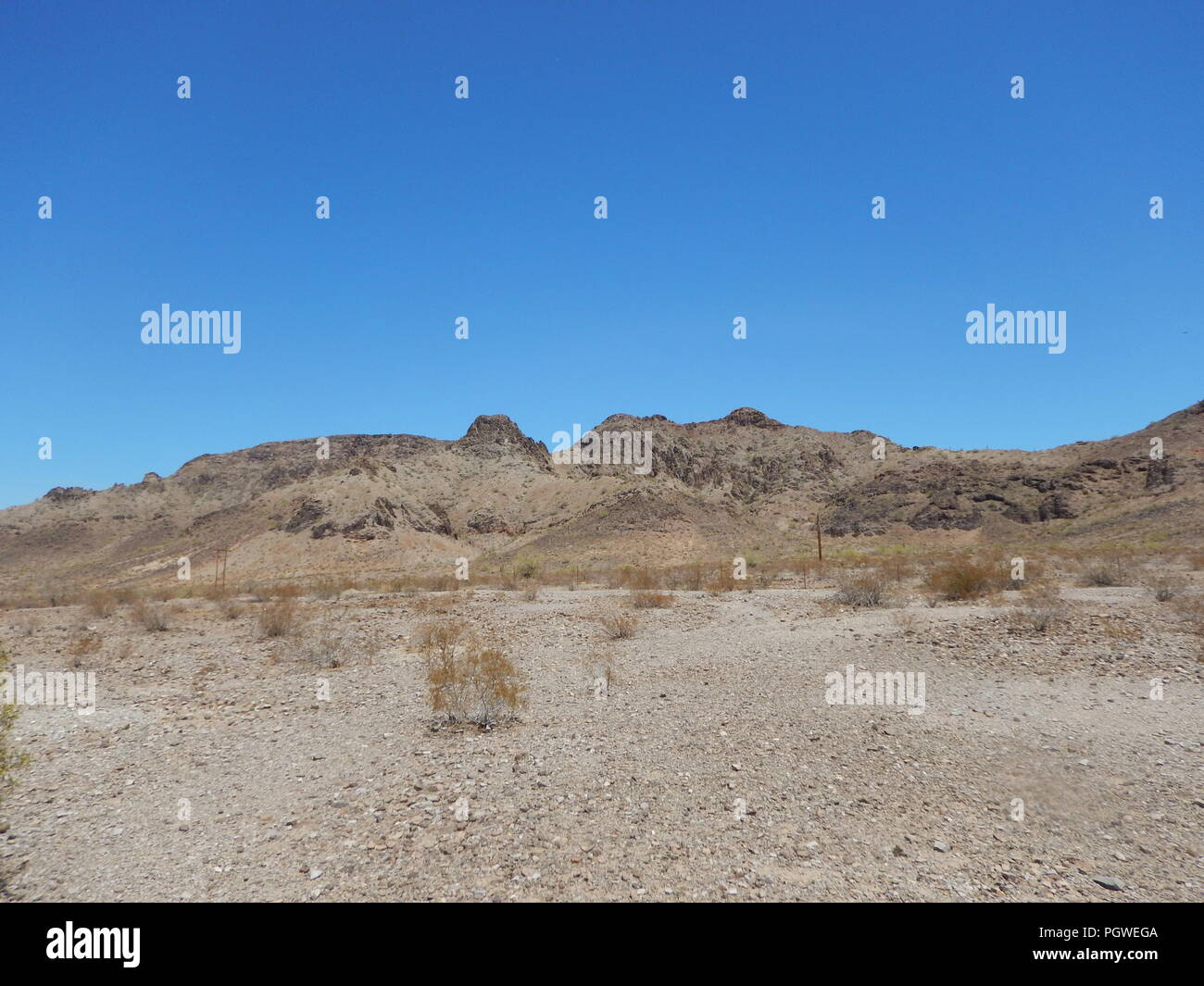 Barren desert landscape with rocky barren desert mountains under blue ...