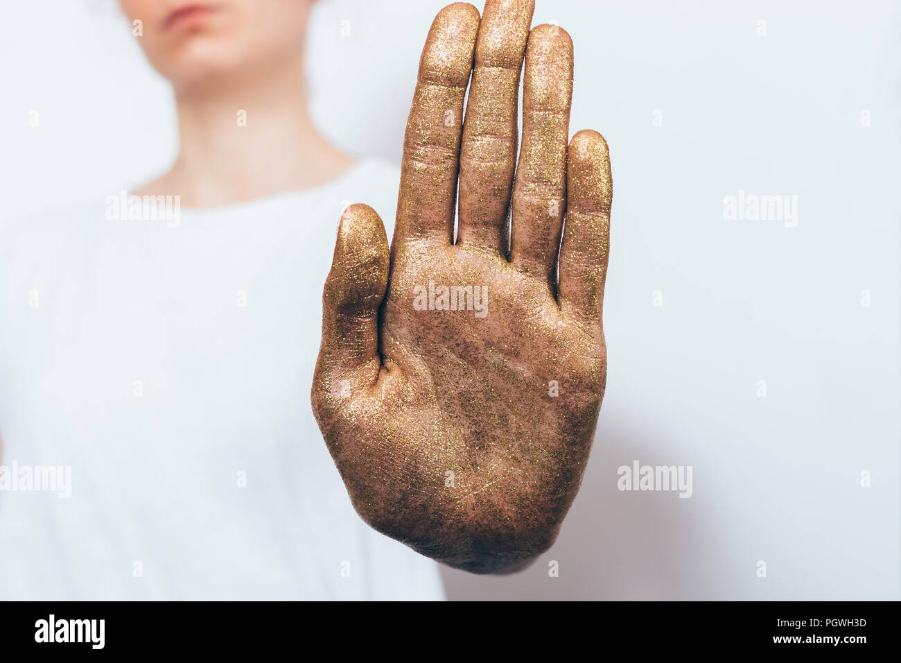 Young woman showing her palm saying no. Female standing on white ...