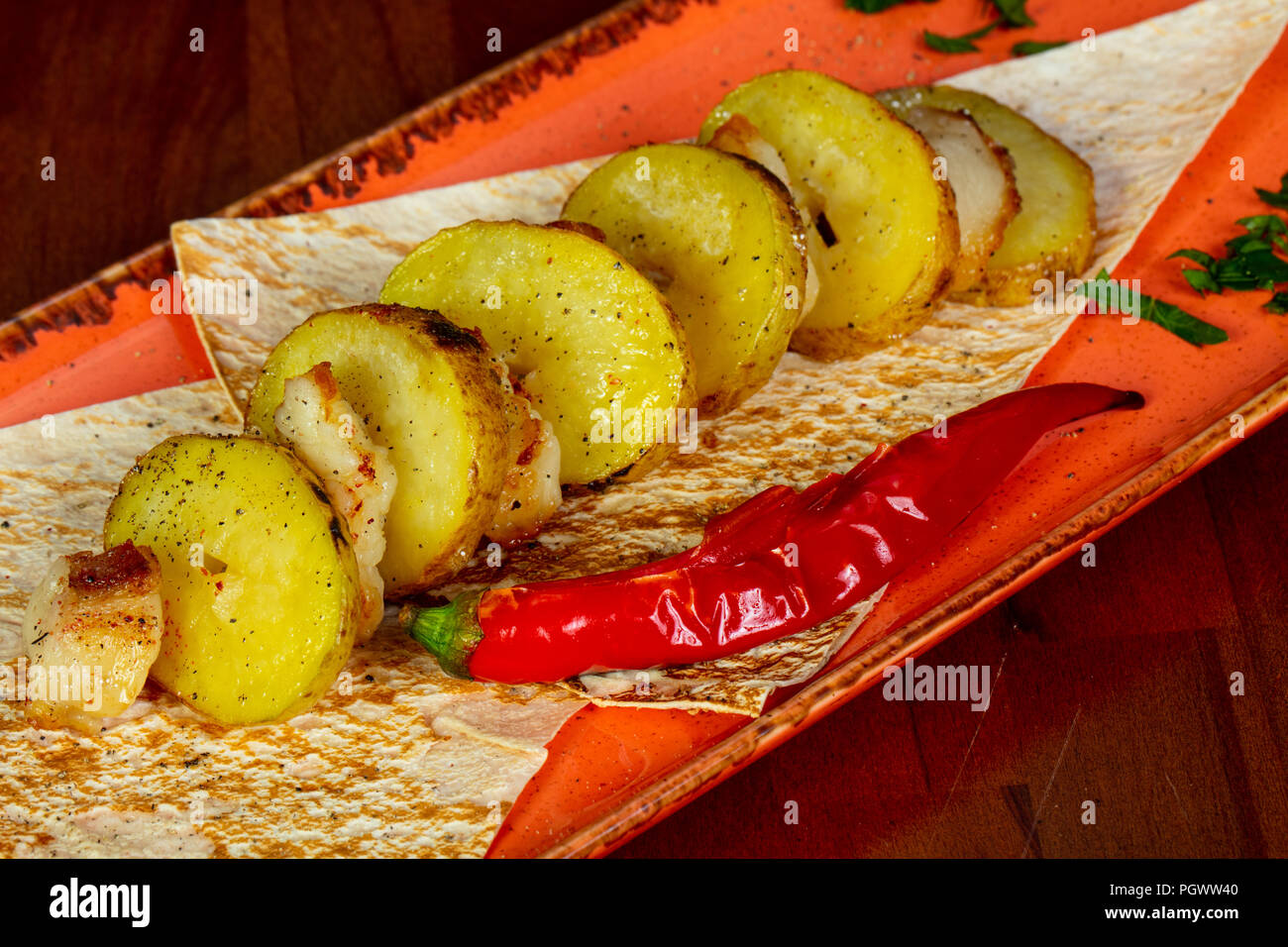 Grilled potato bbq with fat meat Stock Photo - Alamy