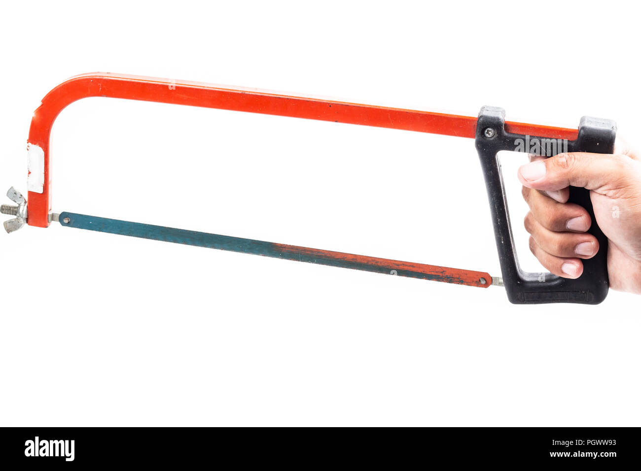 man who serves in his hand a rusty red hacksaw on a white background in ...