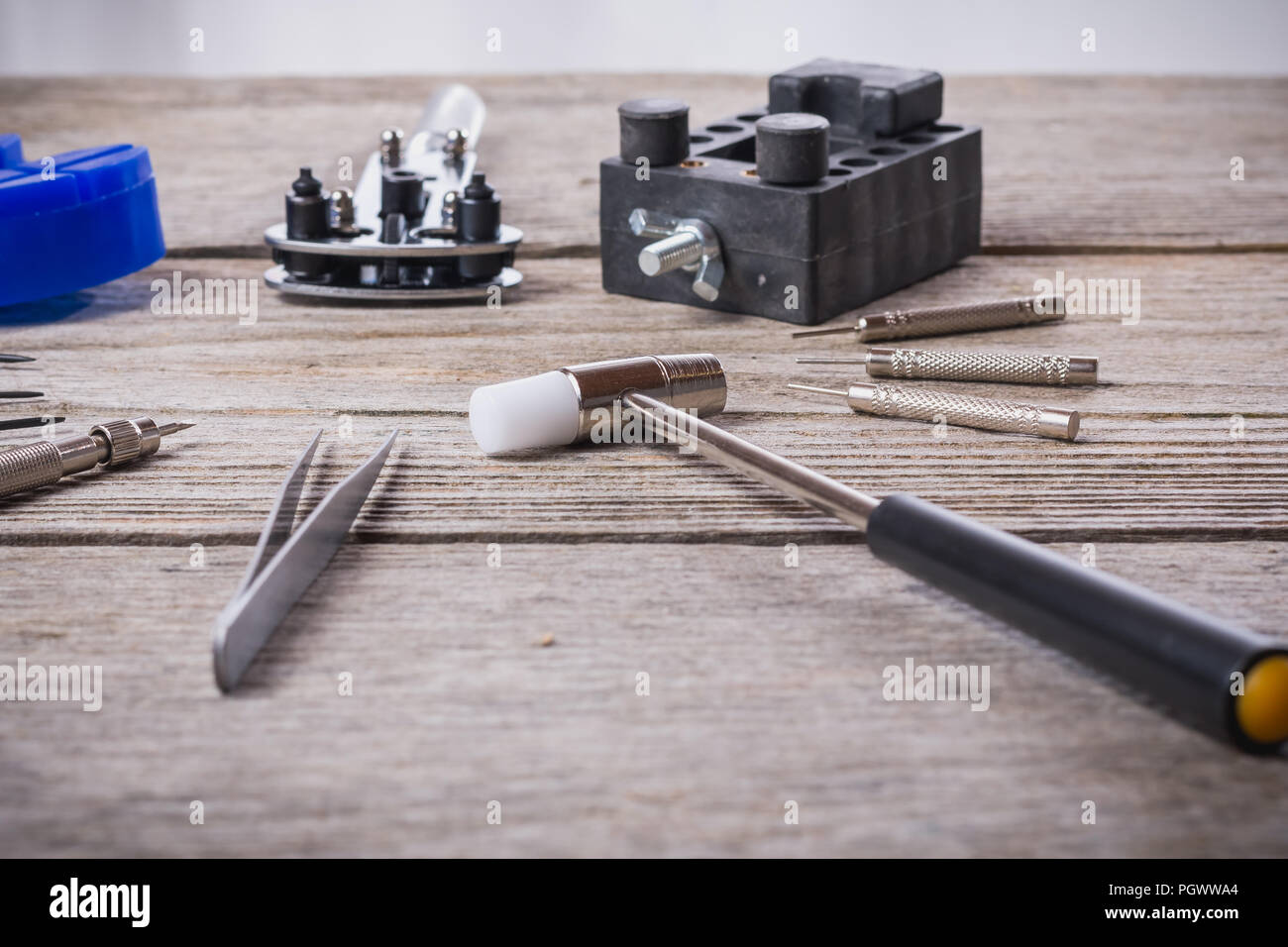 Set of watchmaker tools isolated on a rough wooden board close up Stock ...